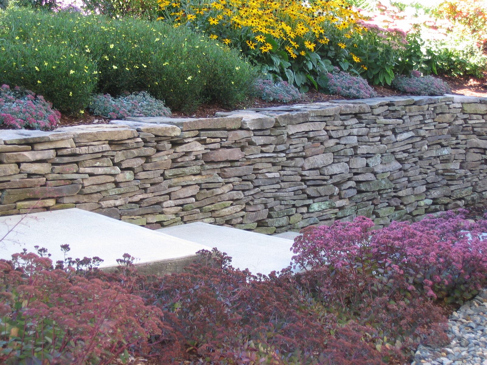 8 Freestanding and Retaining Stone Wall Designs That Will Add Dimension ...